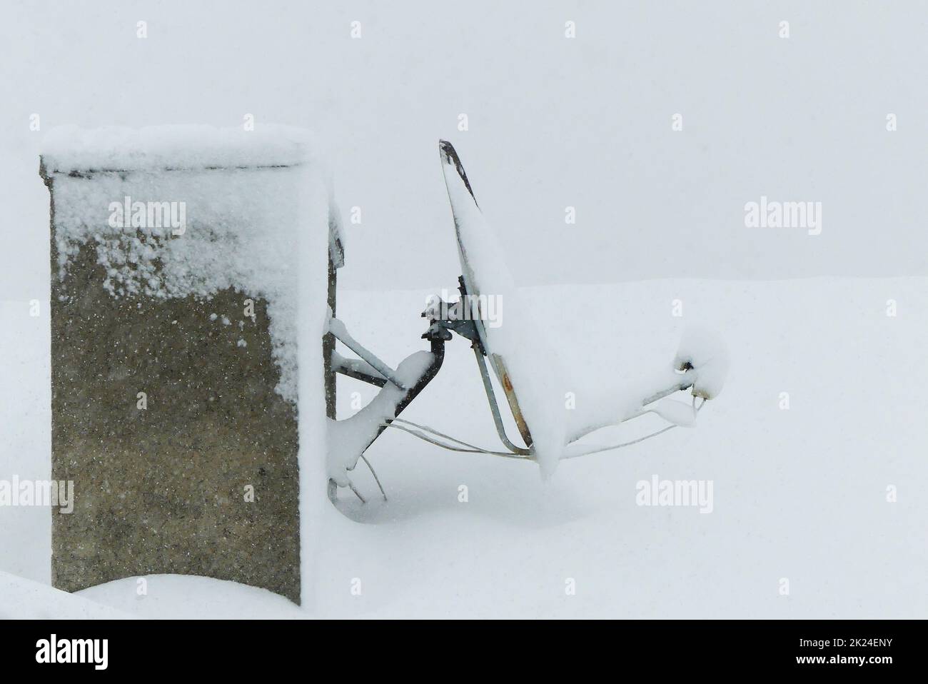 satellite antenna under the snow on the roof, snow accumulated on the ...