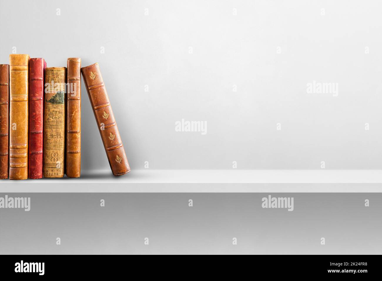 Row of old books on white shelf. Horizontal background scene Stock ...