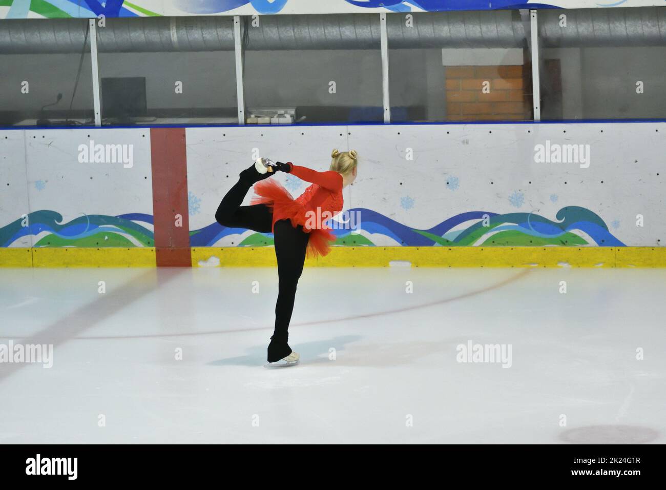 Girl figure skater rolls on a skating rink with artificial ice Stock ...