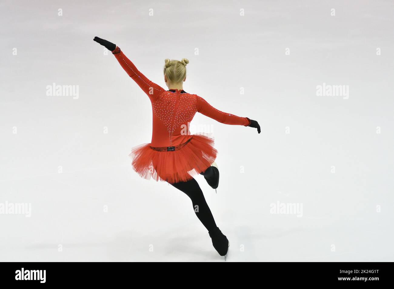 Girl figure skater rolls on a skating rink with artificial ice Stock ...