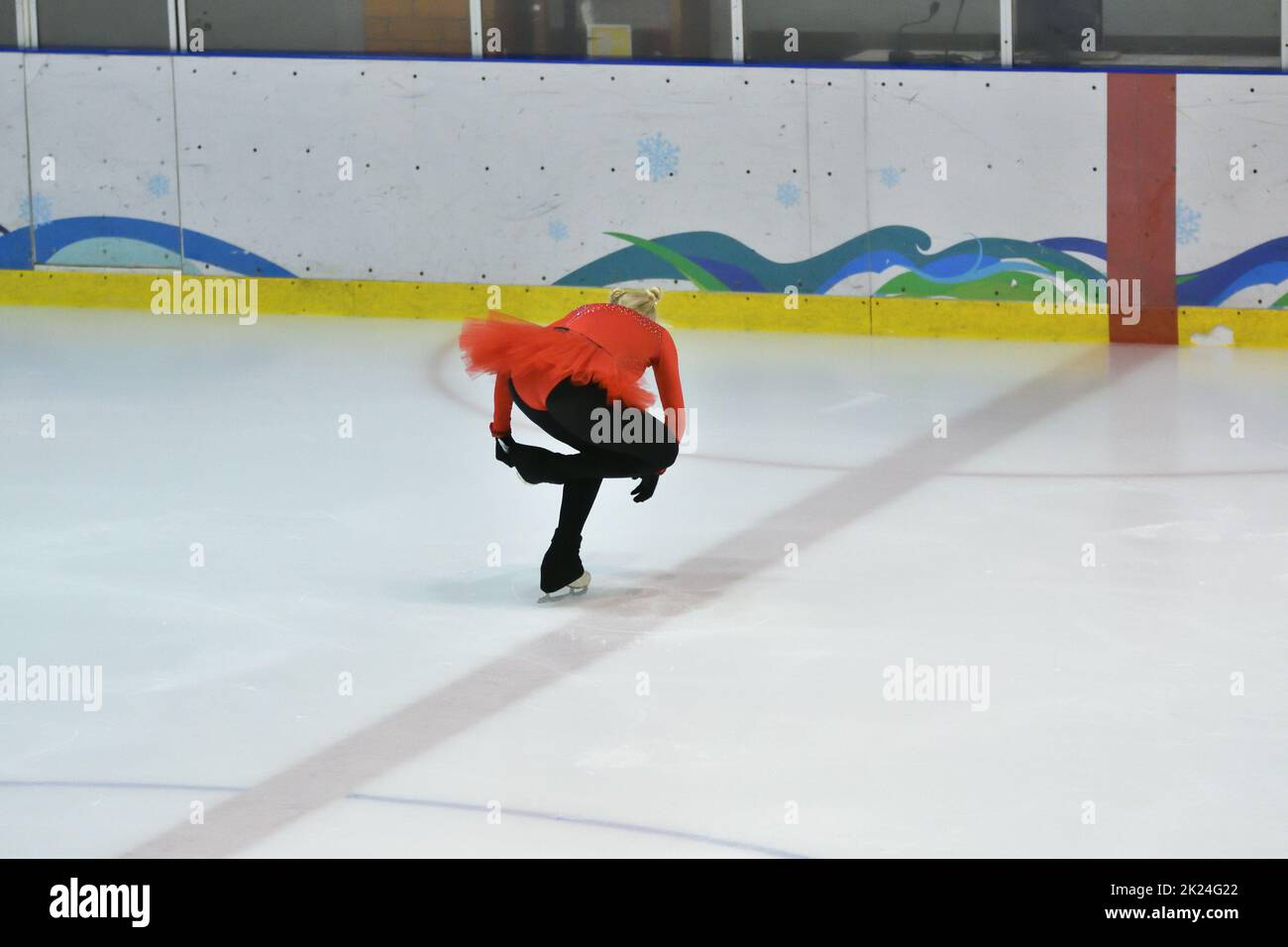 Girl figure skater rolls on a skating rink with artificial ice Stock ...