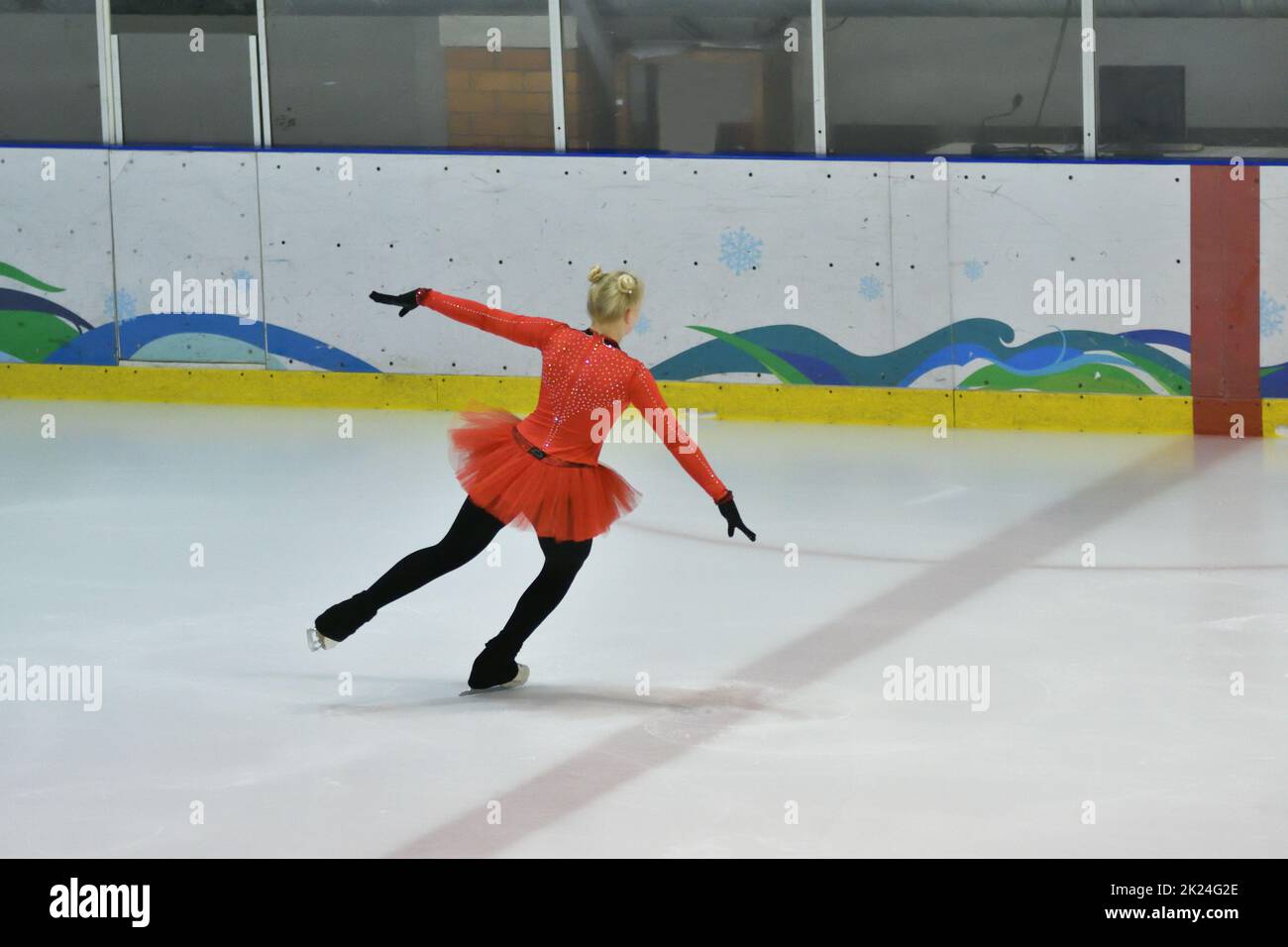 Girl figure skater rolls on a skating rink with artificial ice Stock ...