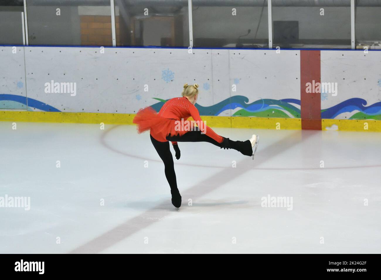 Girl figure skater rolls on a skating rink with artificial ice Stock ...