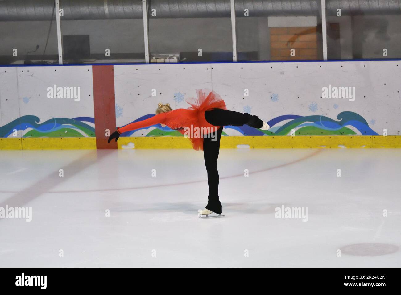 Girl figure skater rolls on a skating rink with artificial ice Stock ...