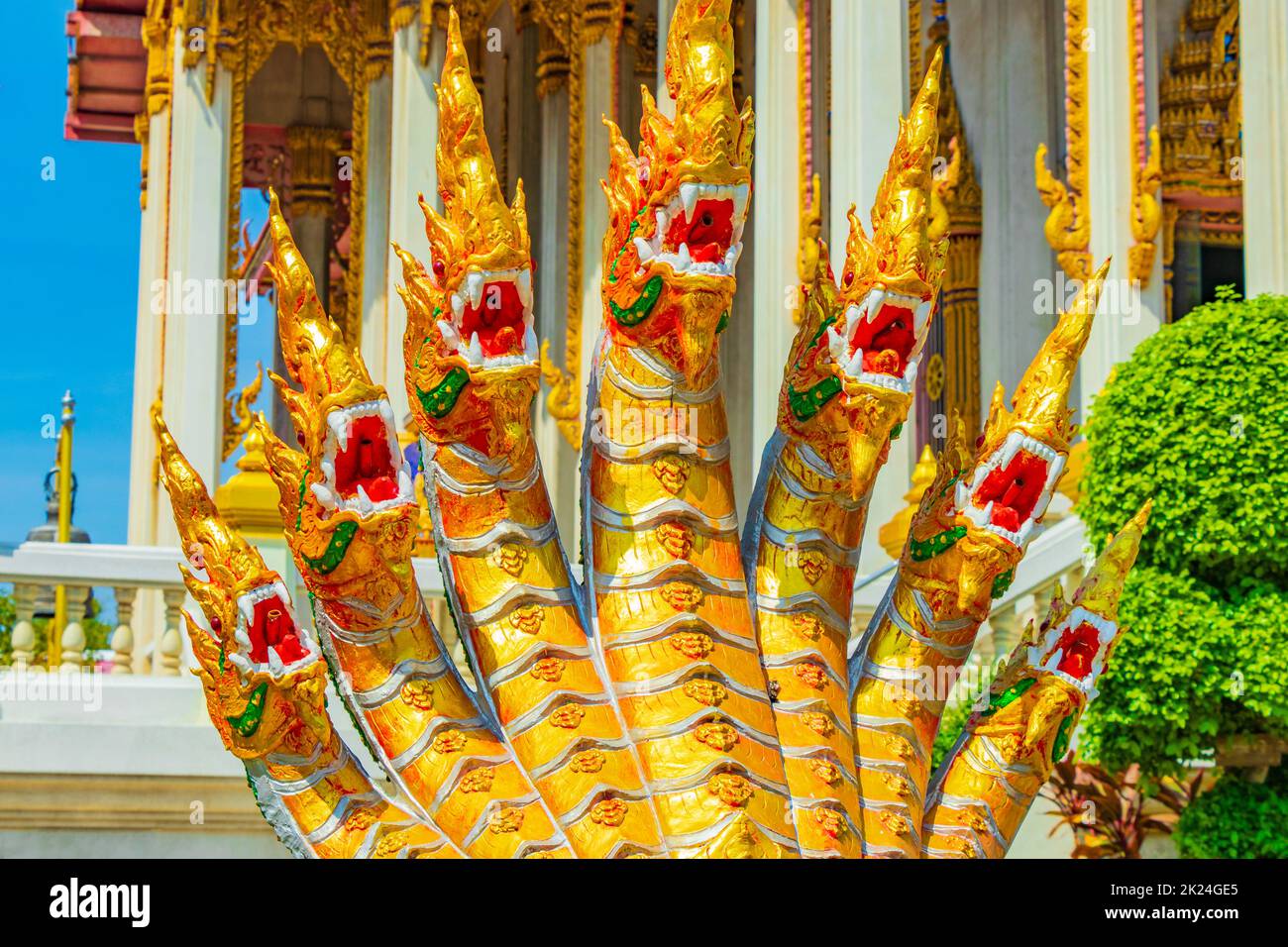 Golden and green dragons dragonfish statues in amazing colorful Wat Don ...
