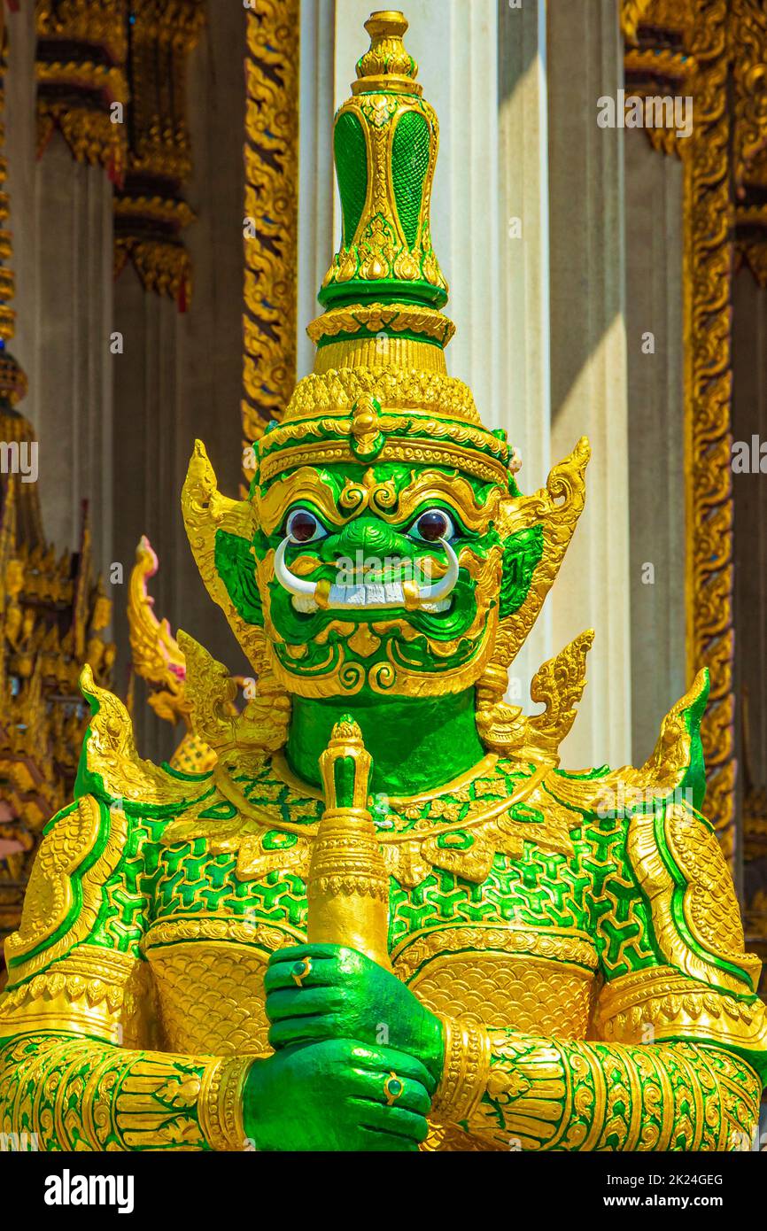 Giant temple guardian Yaksha in gold green at colorful Wat Don Mueang ...