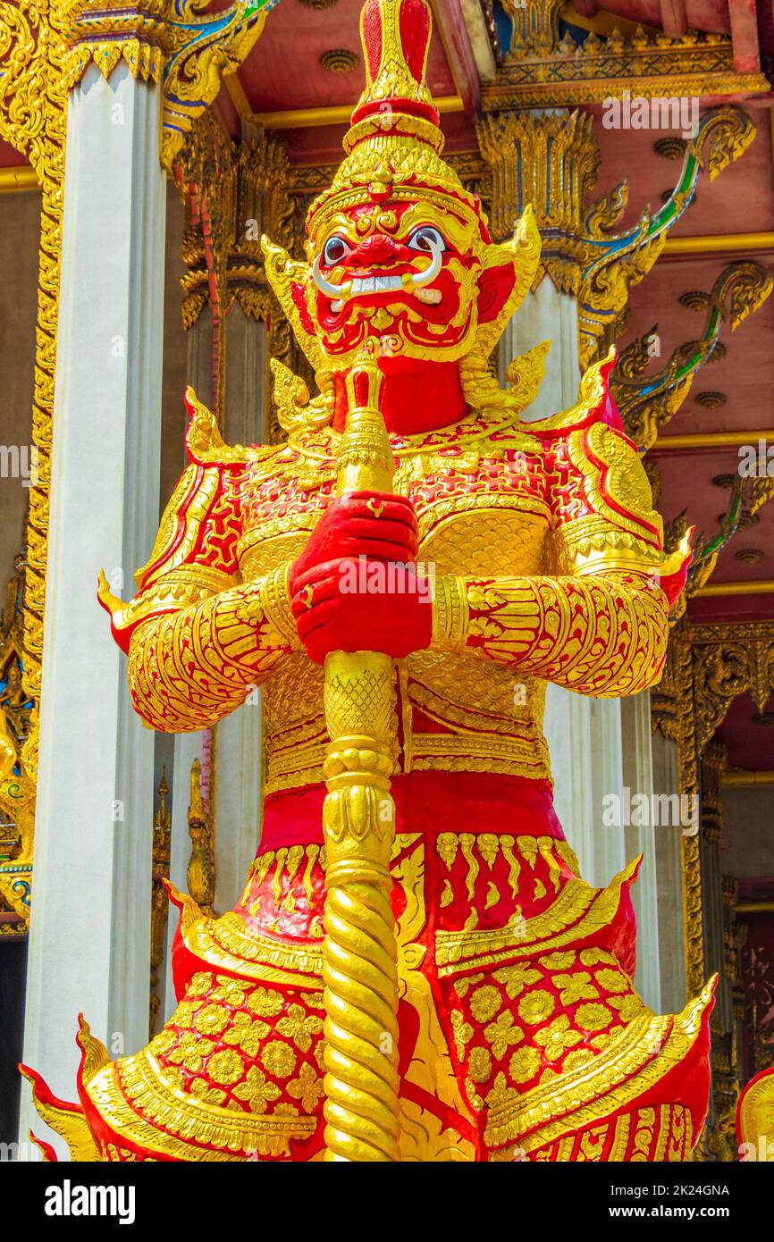 Giant temple guardian Yaksha in gold red at colorful Wat Don Mueang ...