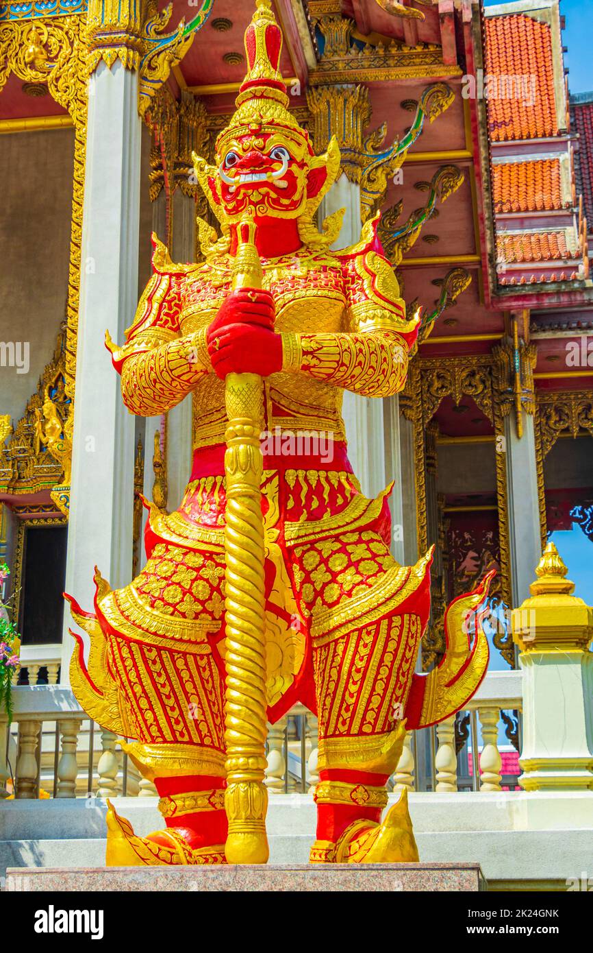Giant temple guardian Yaksha in gold red at colorful Wat Don Mueang ...