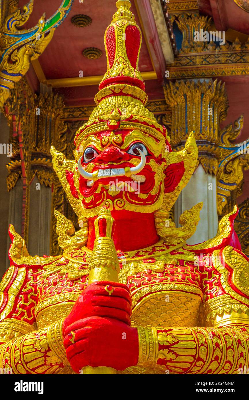 Giant temple guardian Yaksha in gold red at colorful Wat Don Mueang ...