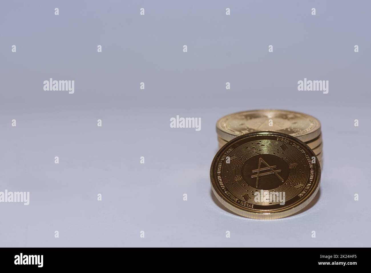 stack of golden valueable ada coins from crypto currency with gray ...