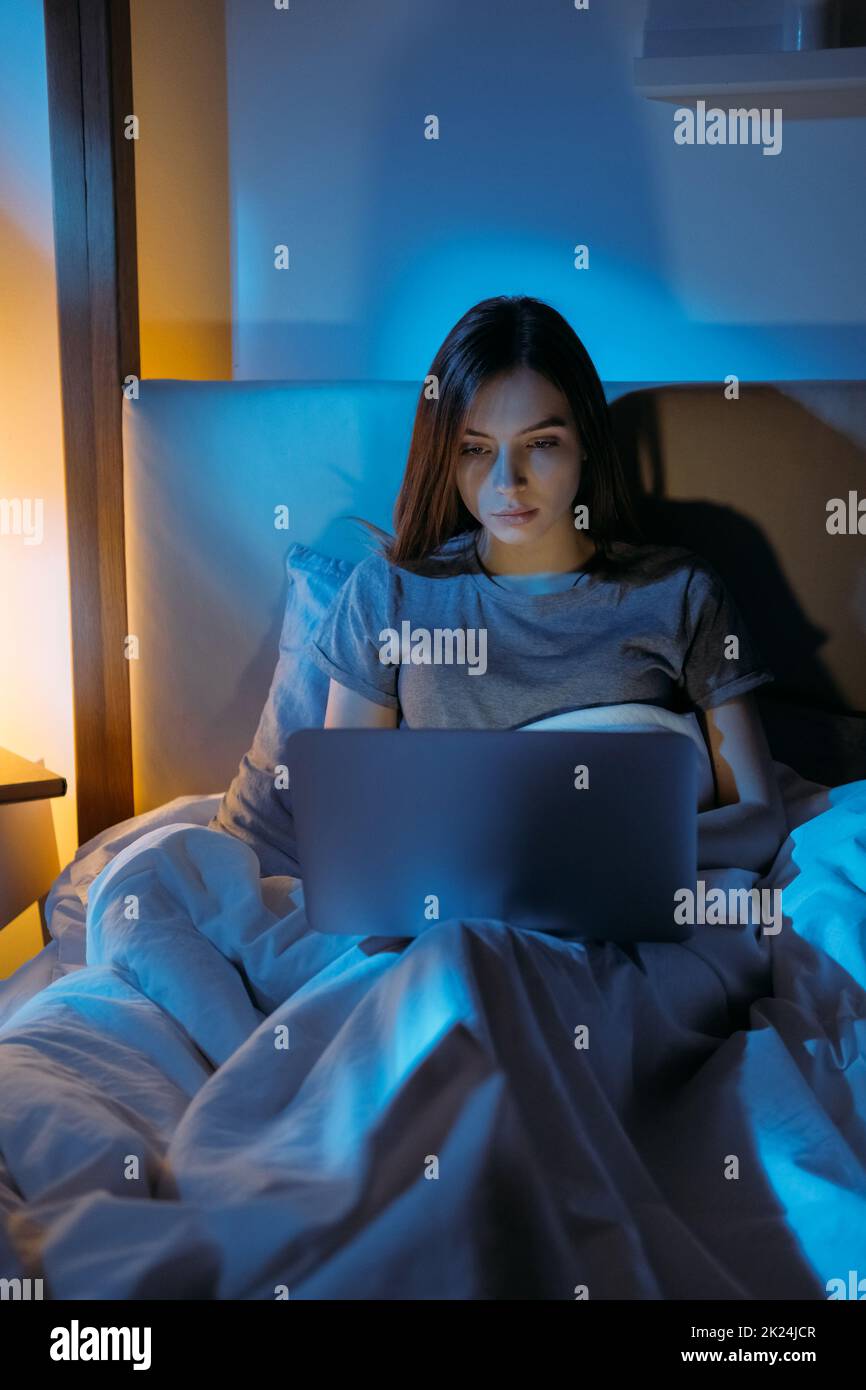 Late movie. Night insomnia. Bedtime leisure. Tired curious woman ...