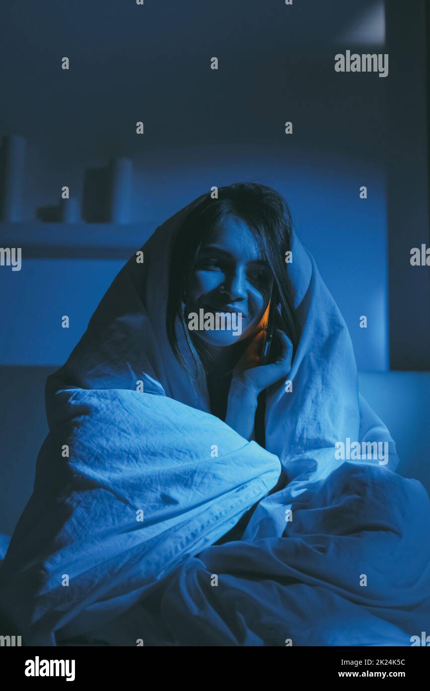 Late phone call. Night leisure. Mobile communication. Happy woman ...