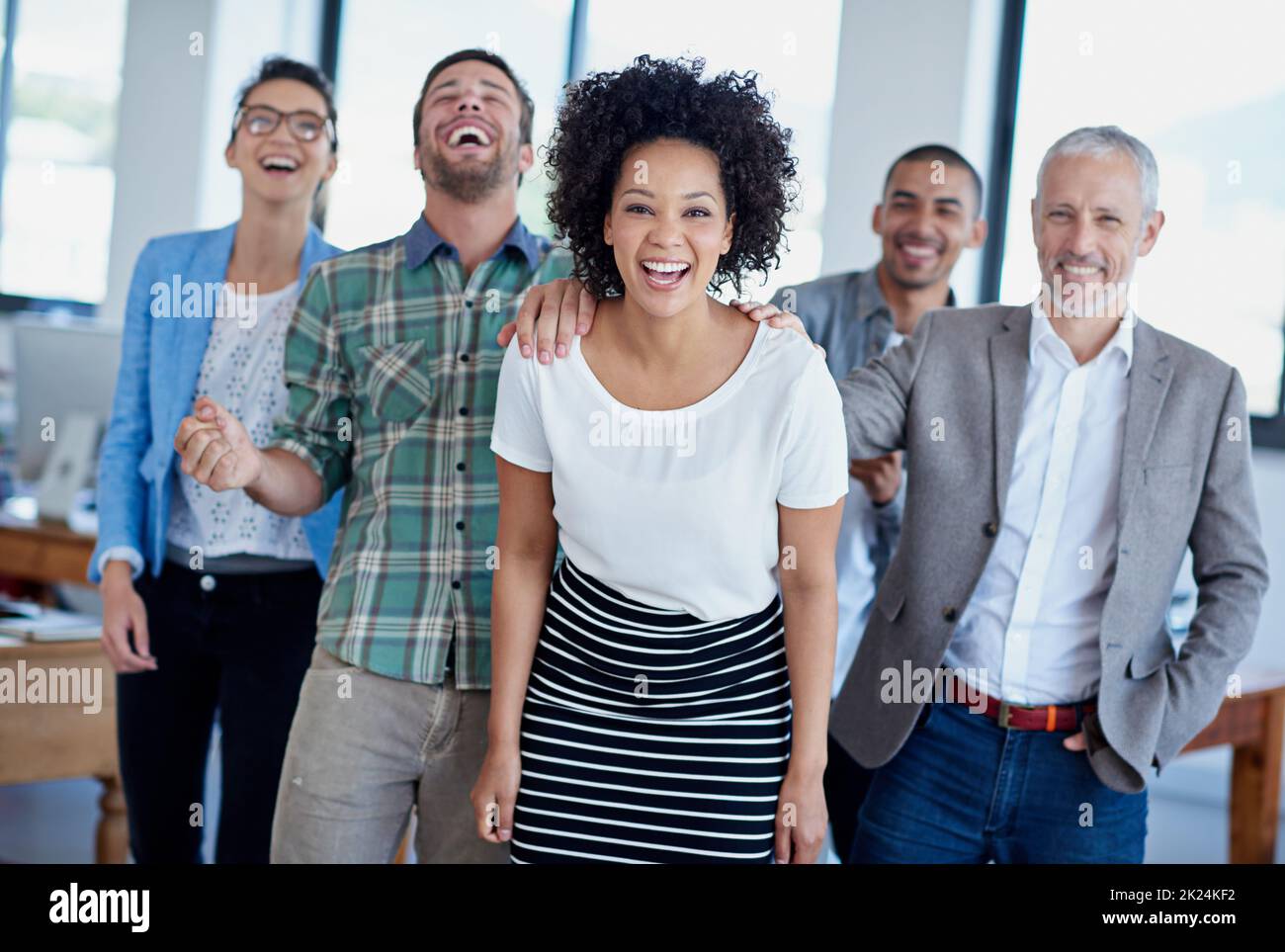 Success deserves a celebration. a group of happy coworkers celebrating standing in an office ...