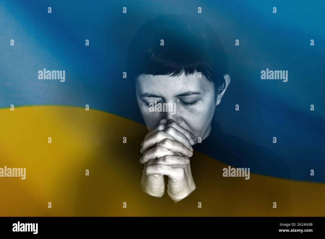 Sad woman with Ukraine flag at background praying. Concept of standing ...