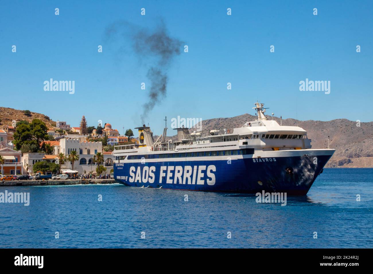 SYMI, Greece - JUN 03, 2021. A large ferry docking in the pictorial ...