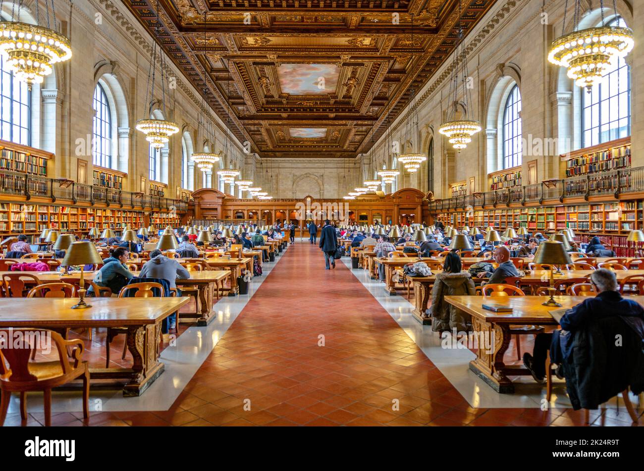 People and students sitting in a large Hall in the New York Public ...