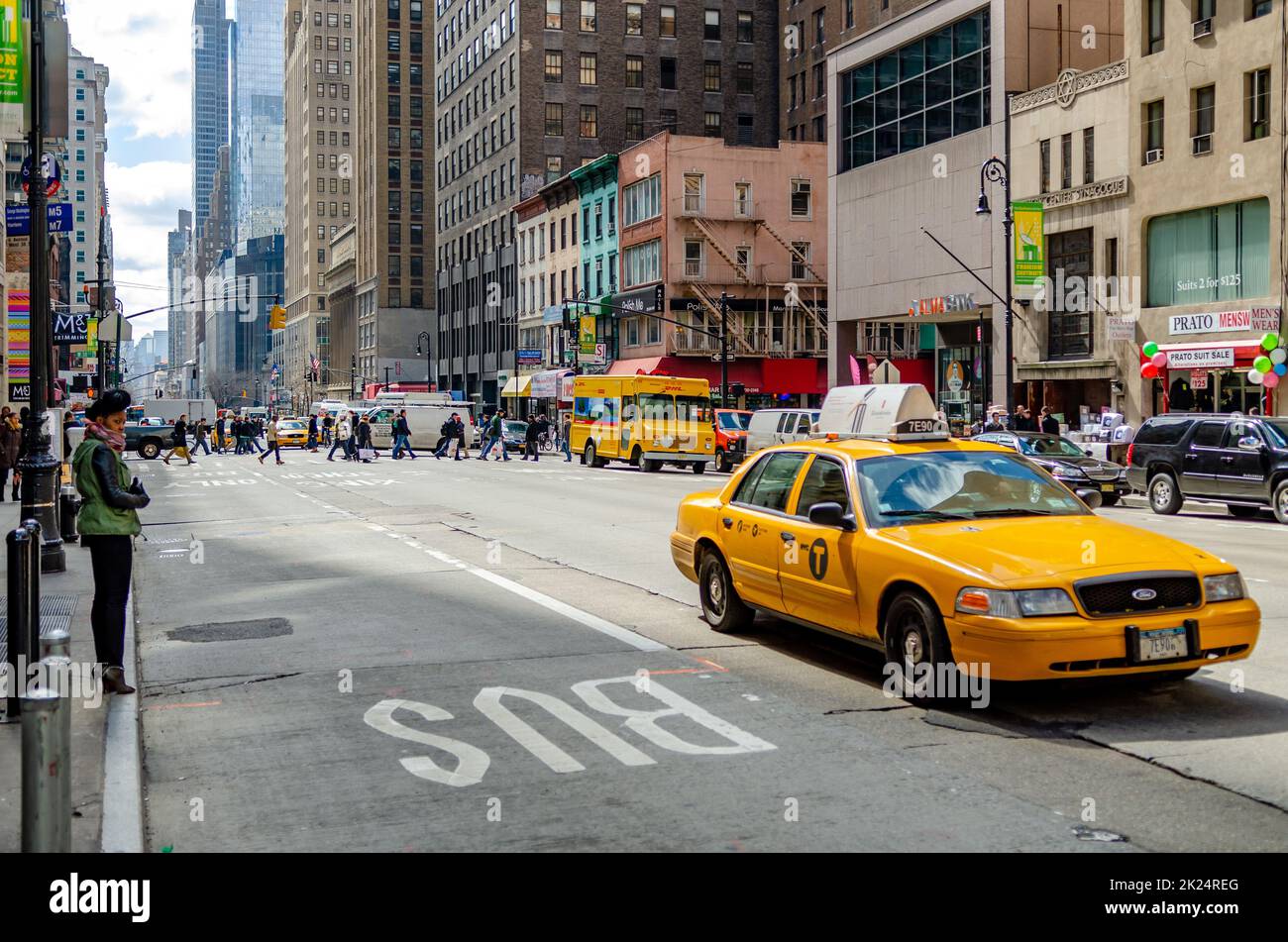 Black Woman standing on the sidewalk of a wide street in Manhattan, New ...