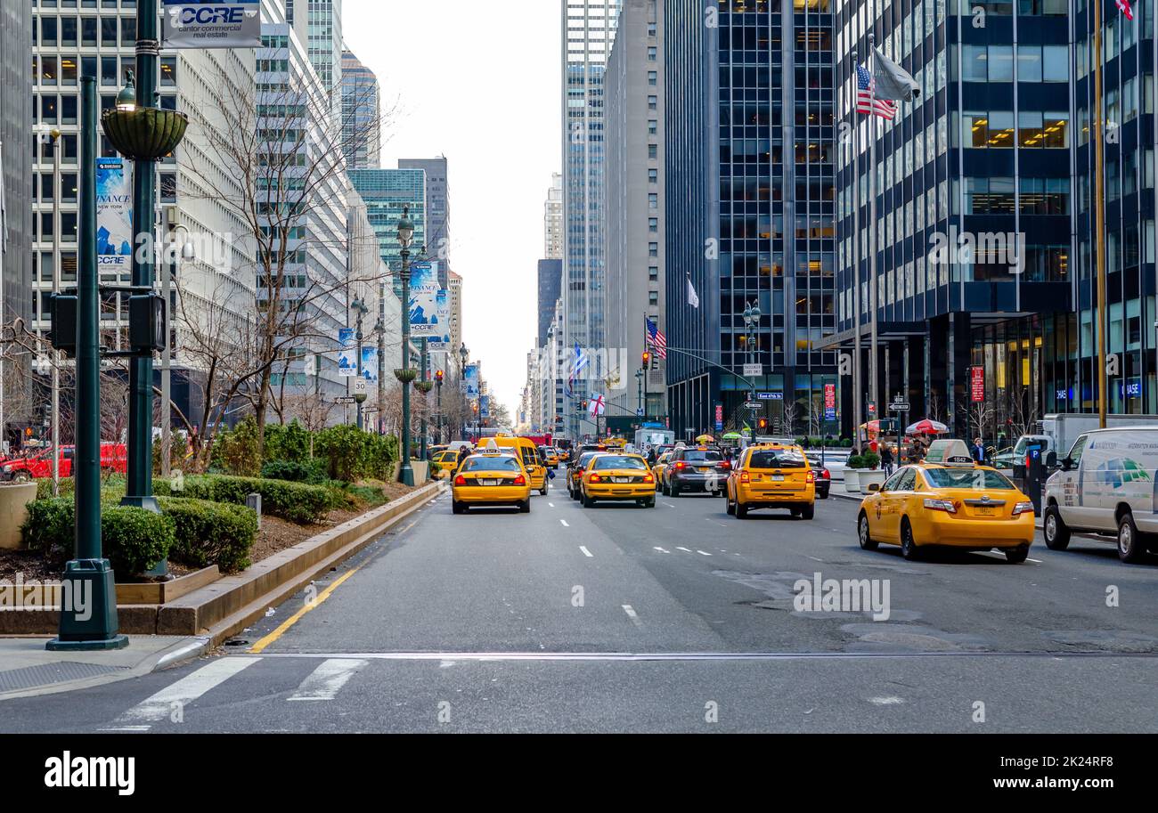 Yellow Taxi Cabs on a wide street in Manhattan rear view in the evening ...