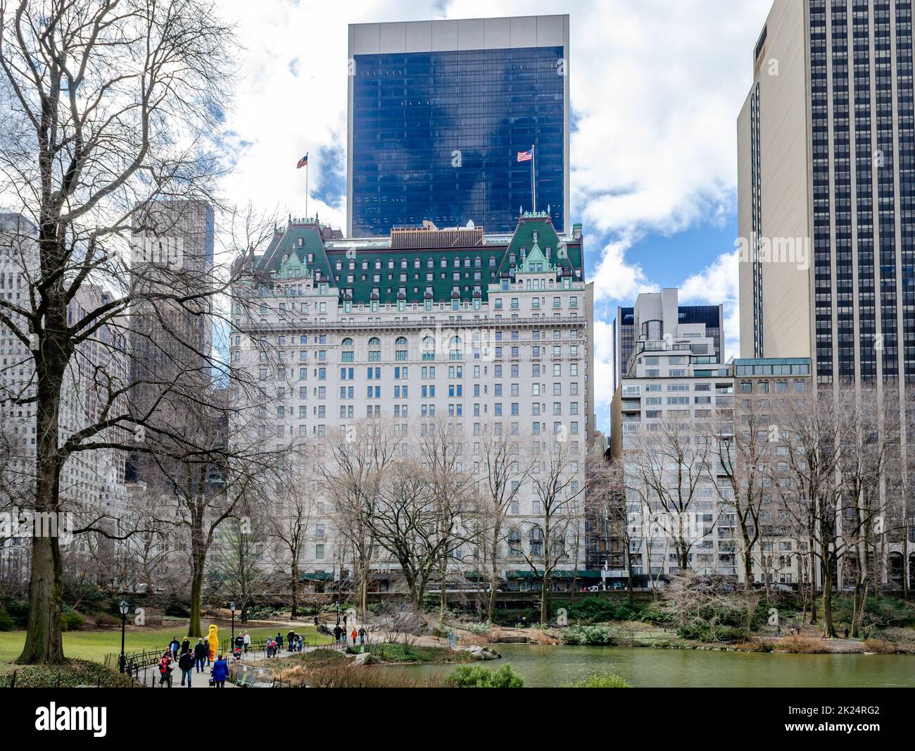 The Pond at Central Park Lake during winter with The Plaza Hotel in ...