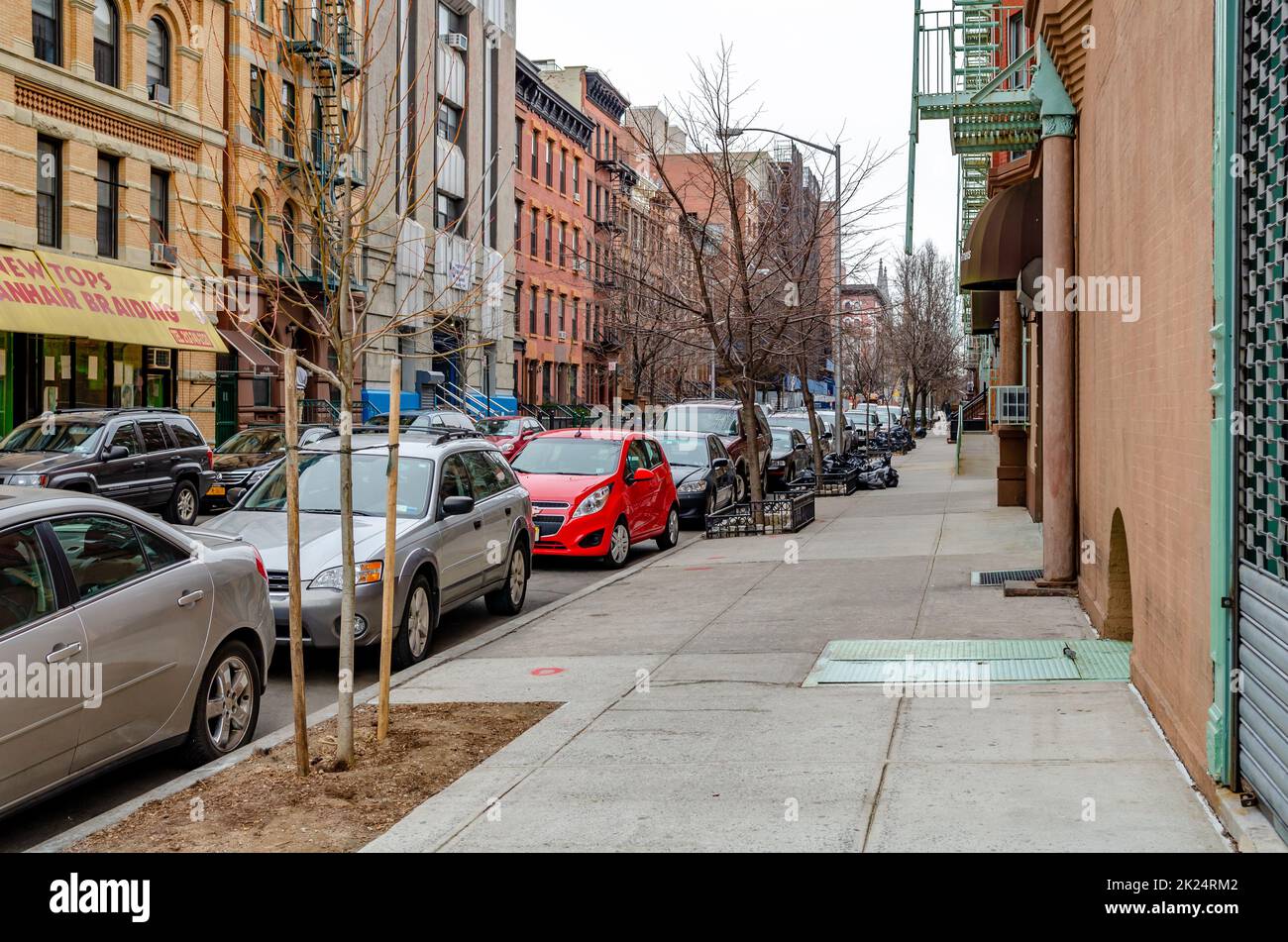 Street in Harlem with retail store and different old residential ...