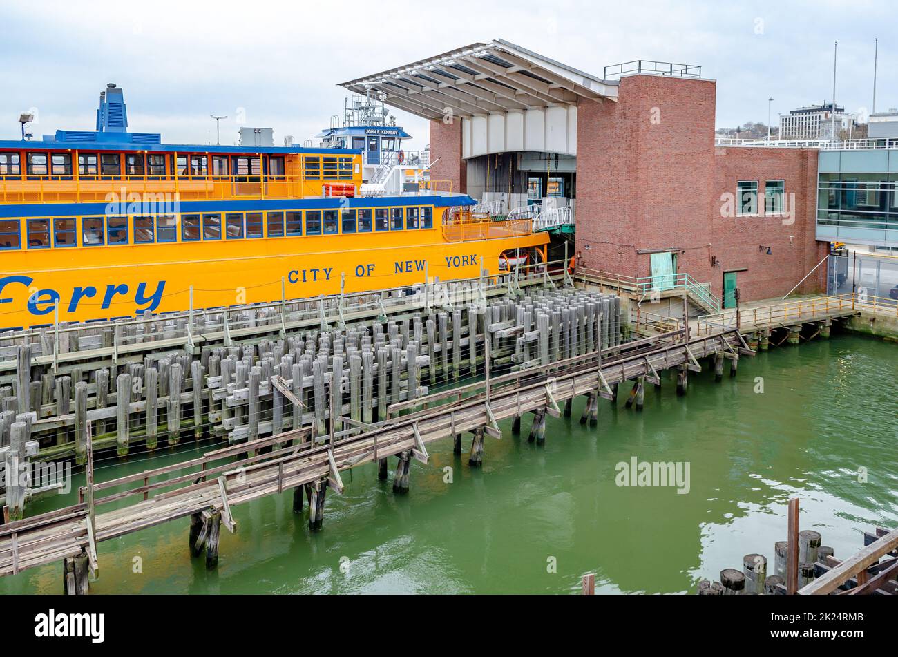 Yellow Staten Island Ferry at Staten Island Terminal, side view, wood ...