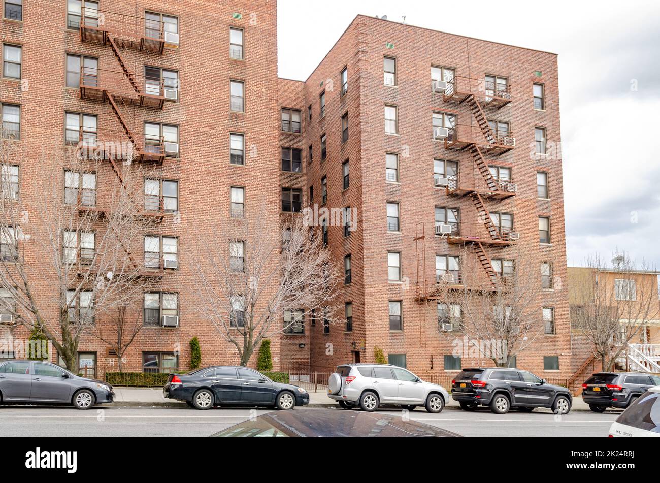 Brown Residential Building in Coney Island with lots of cars parked in ...