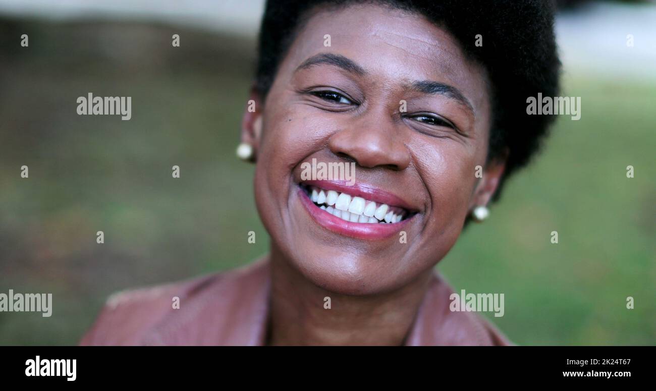 Portrait black African woman smiling outside Stock Photo - Alamy
