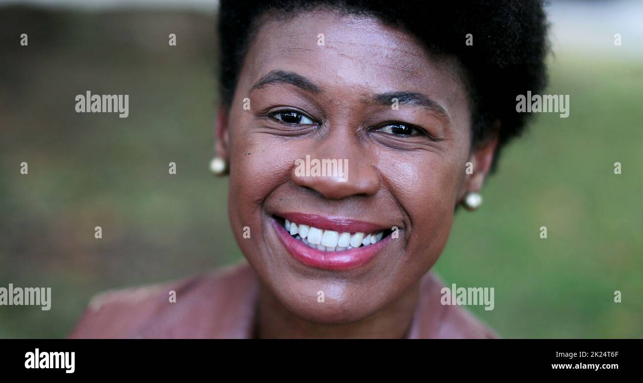 Portrait black African woman smiling outside Stock Photo - Alamy