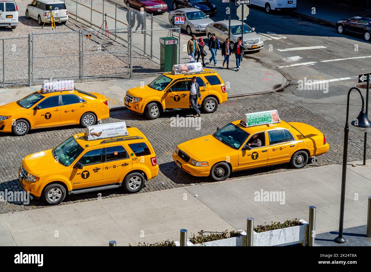 Different car models of Yellow taxi cabs parked in side street in ...
