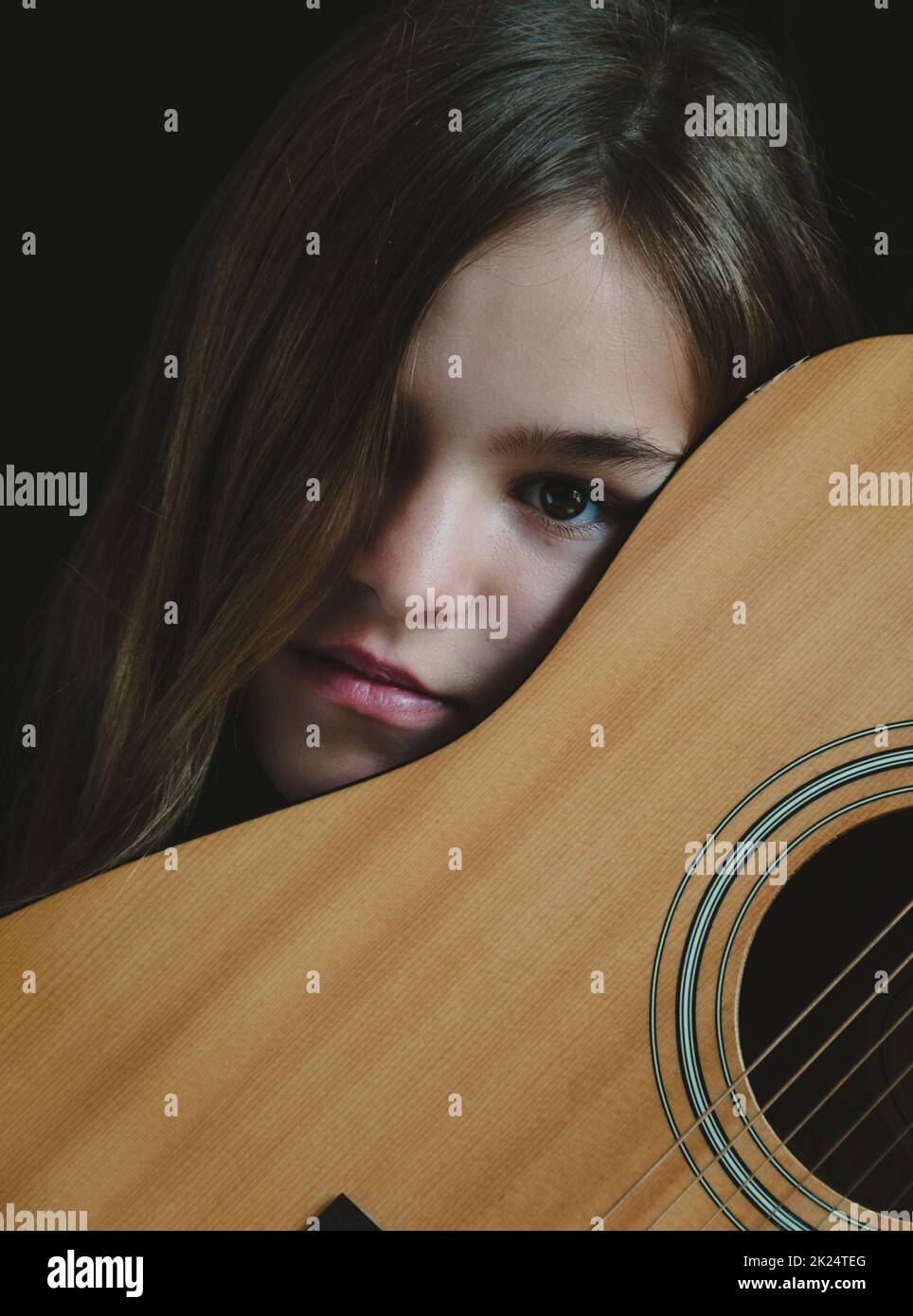 portrait of a young girl ,with an acoustic guitar , concept of hobbys ...