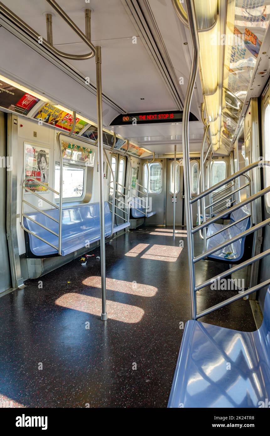 Subway New York City indoors with blue benches and advertisement, empty ...