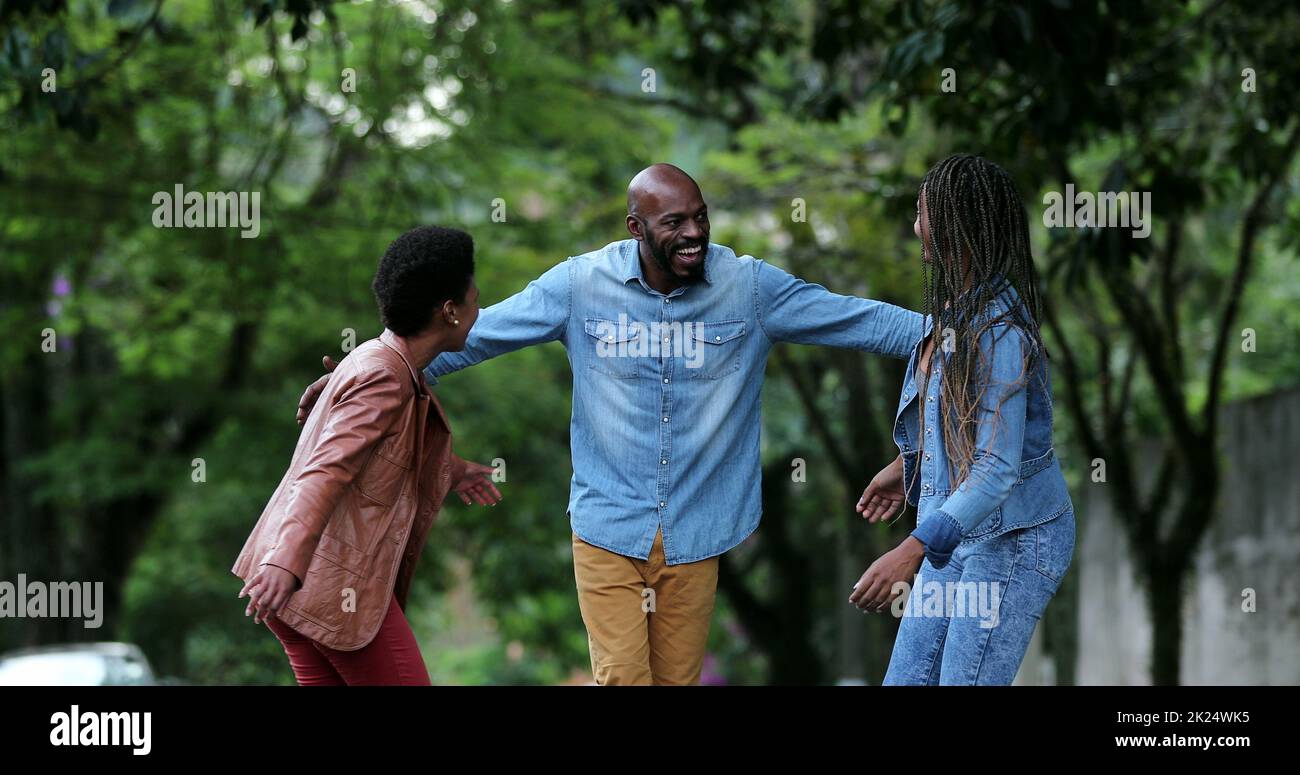 Three happy people posing together. African ethnicity, friends smiling ...