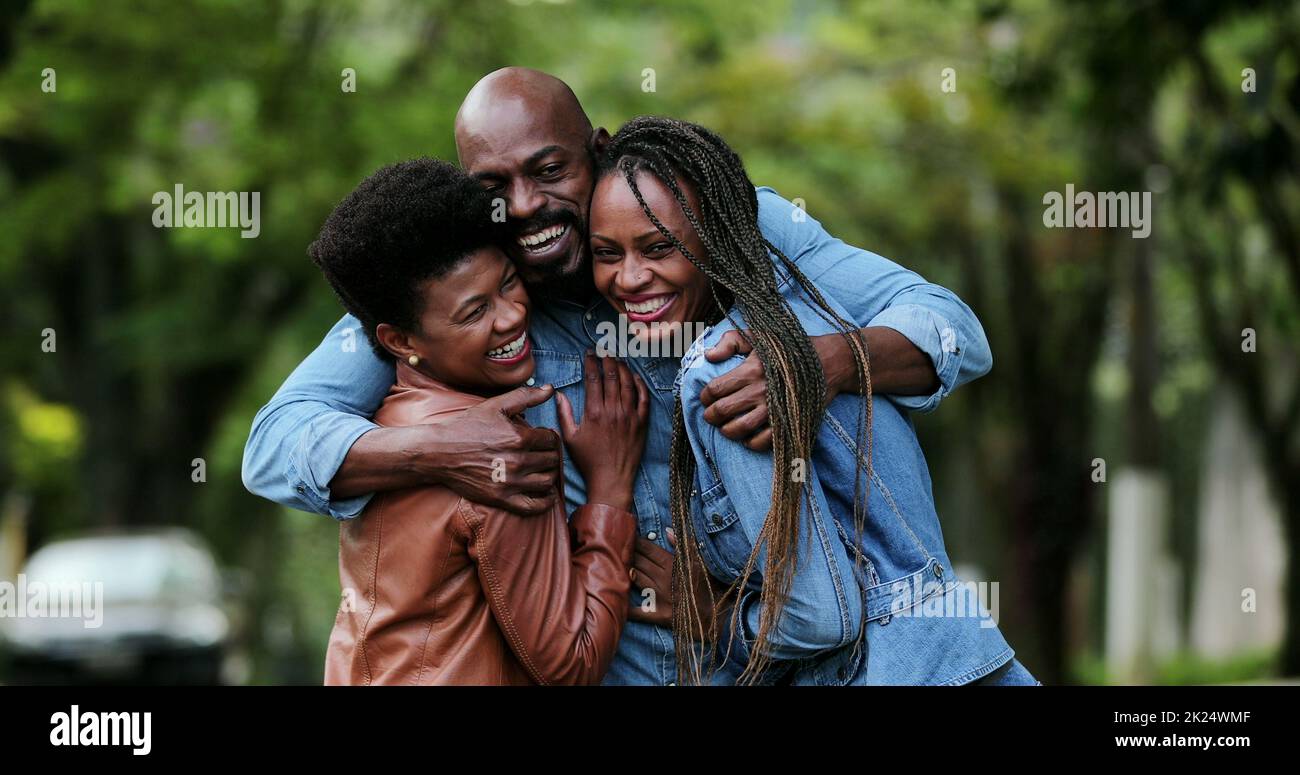 Three Friends hugging each other. African man and women embrace smiling ...