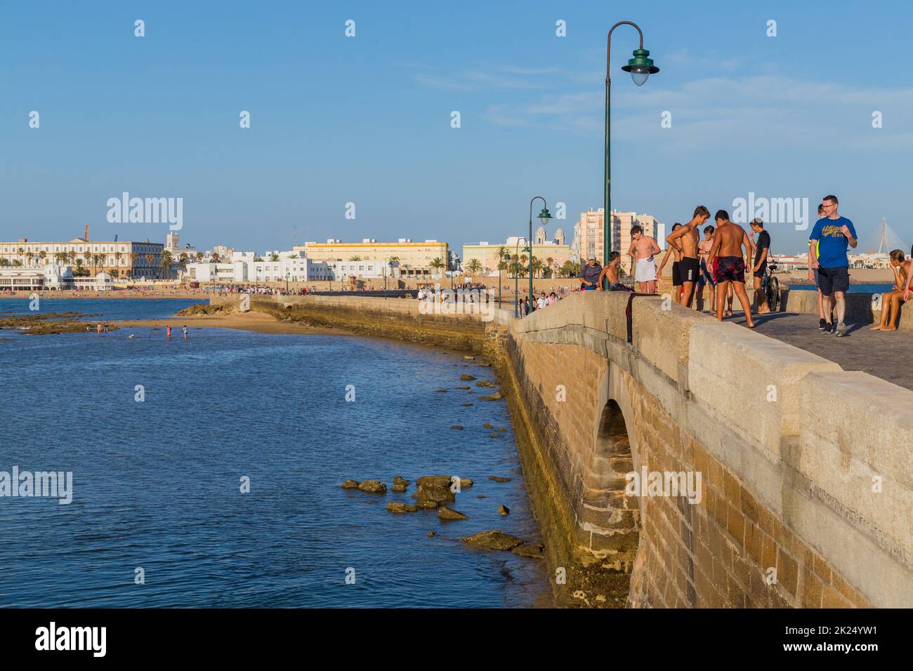Cadiz, Spain - August 16, 2021. People enjoying La Caleta with the San ...