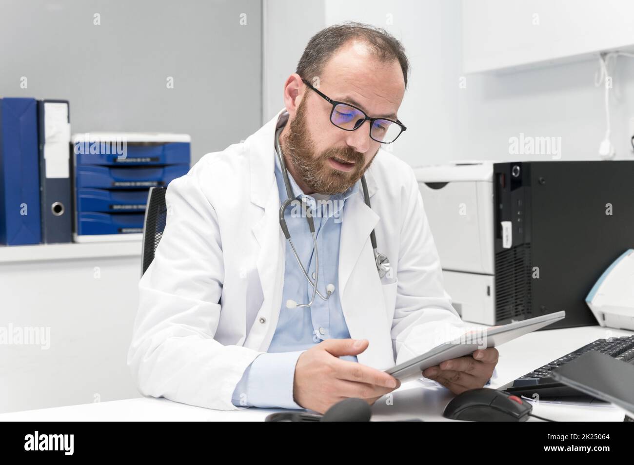 Doctor using his tablet computer at work. High quality photo Stock ...