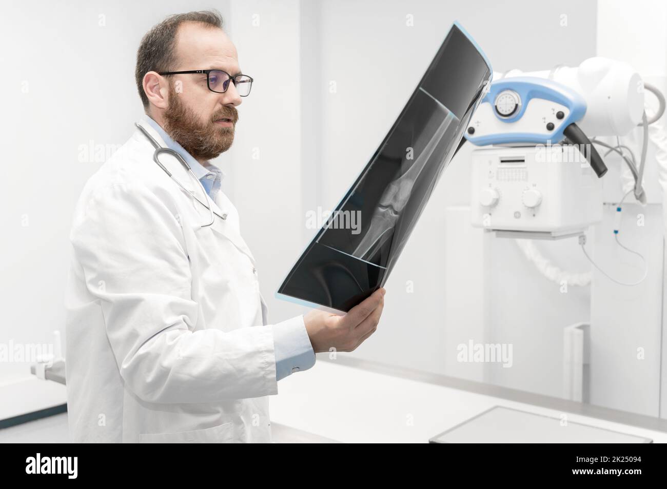 Doctor examine a film x-ray of a patient at radiology room. High ...