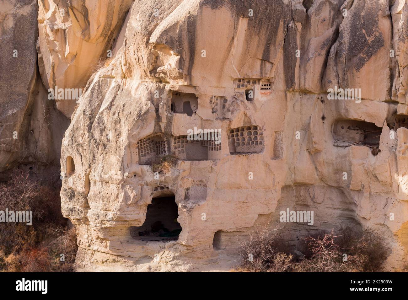 Cave houses and buildings in Cappadocia, Turkey. Stone peaks with doors ...