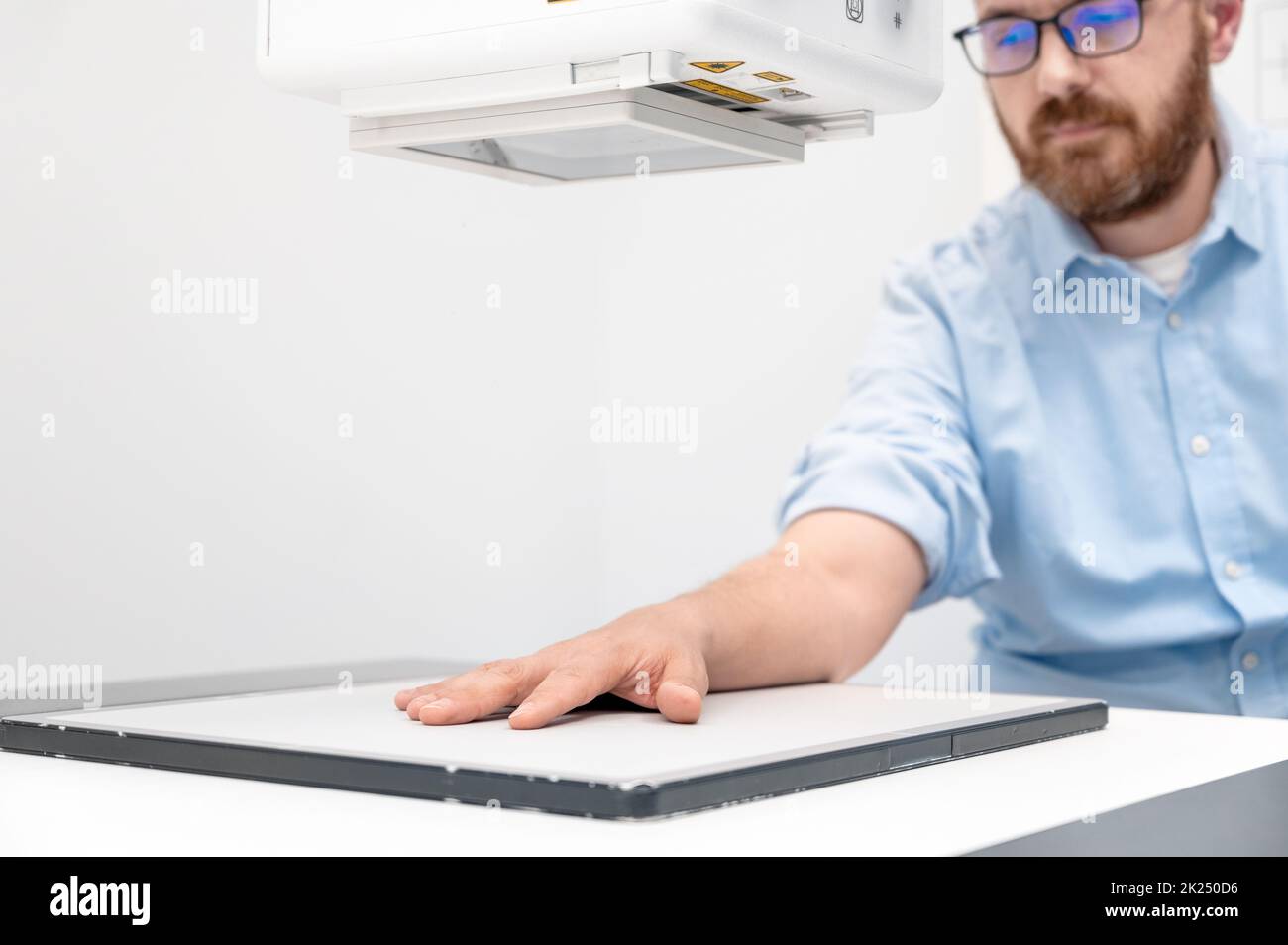 Man in x-ray room having medical scan examination in a modern hospital ...