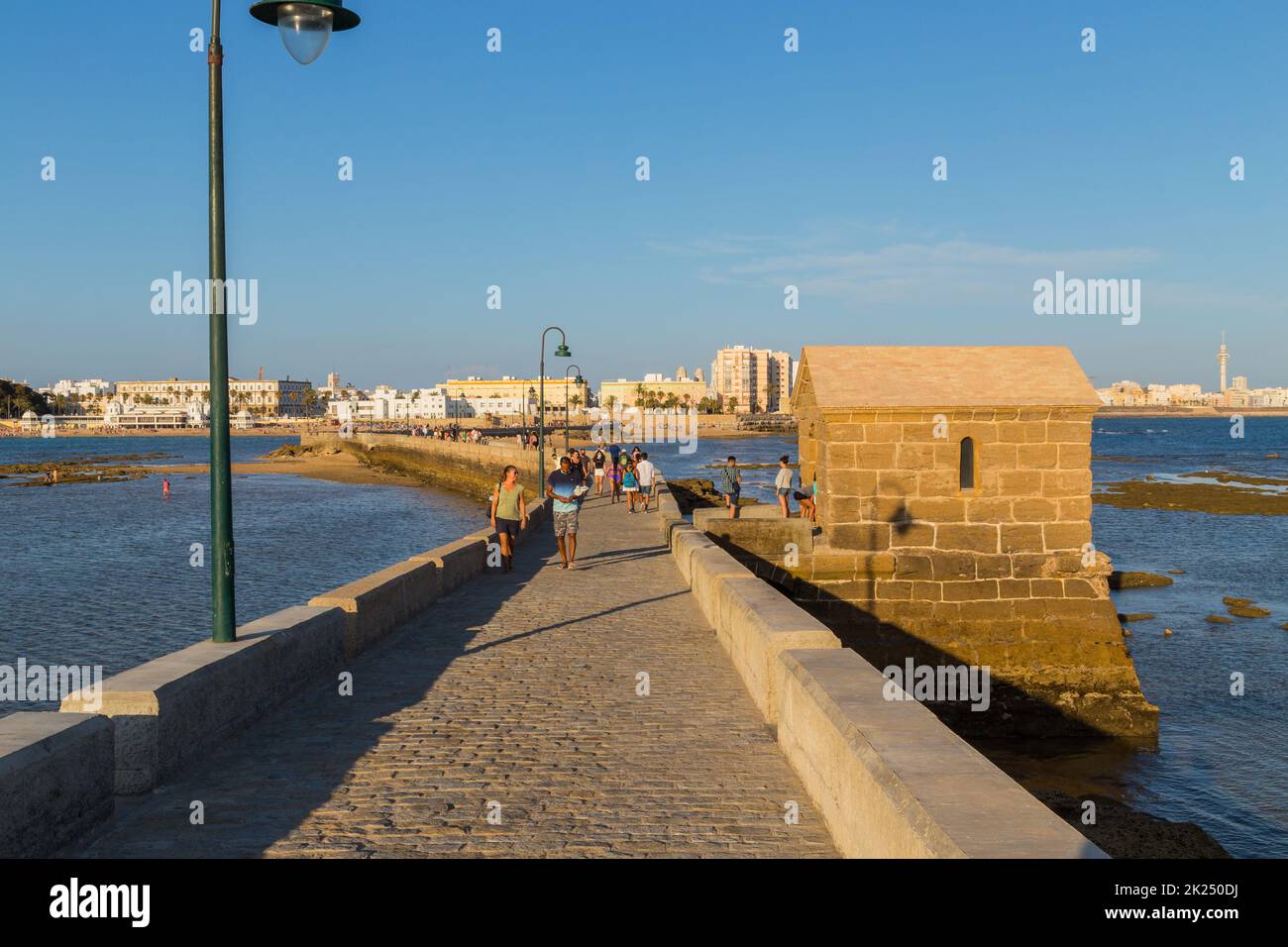 Cadiz, Spain - August 16, 2021. People enjoying La Caleta with the San ...