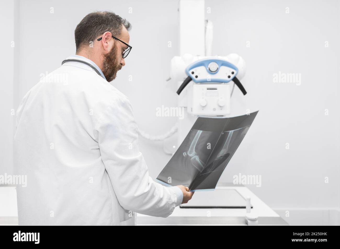 Doctor examine a film x-ray of a patient at radiology room. High ...