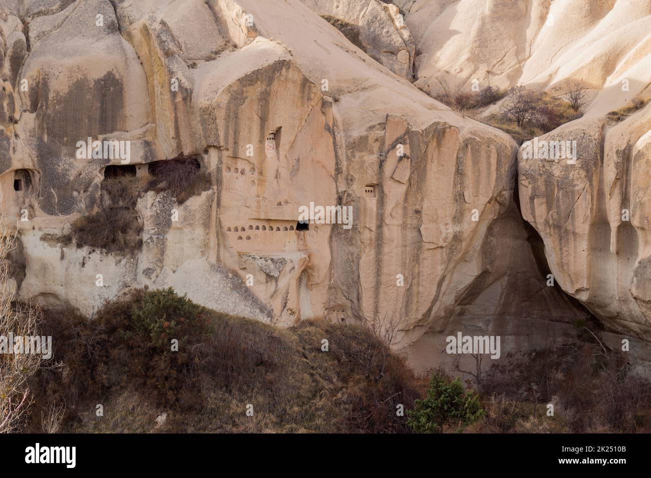 Cave houses and buildings in Cappadocia, Turkey. Stone peaks with doors ...