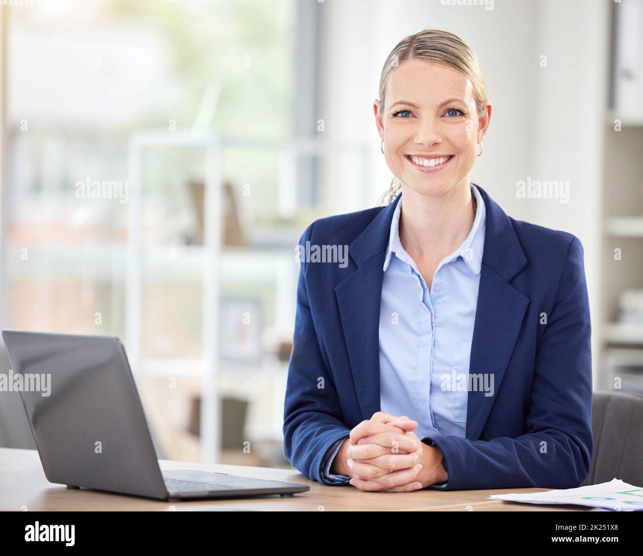 Happy business woman, laptop and smile in success for corporate management at an office desk in ...