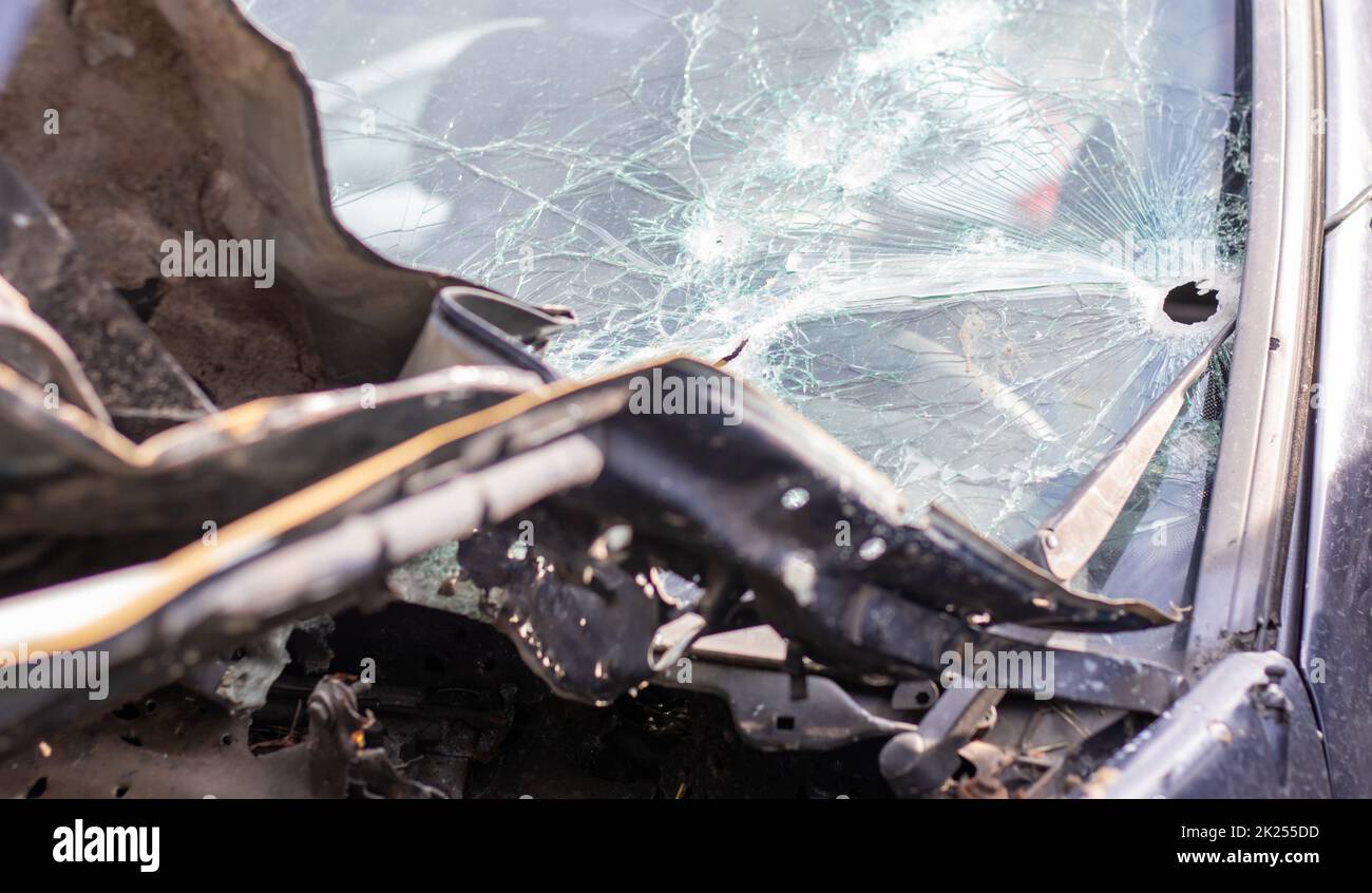 Holes on the windshield of the car, it was shot from a firearm. Bullet ...