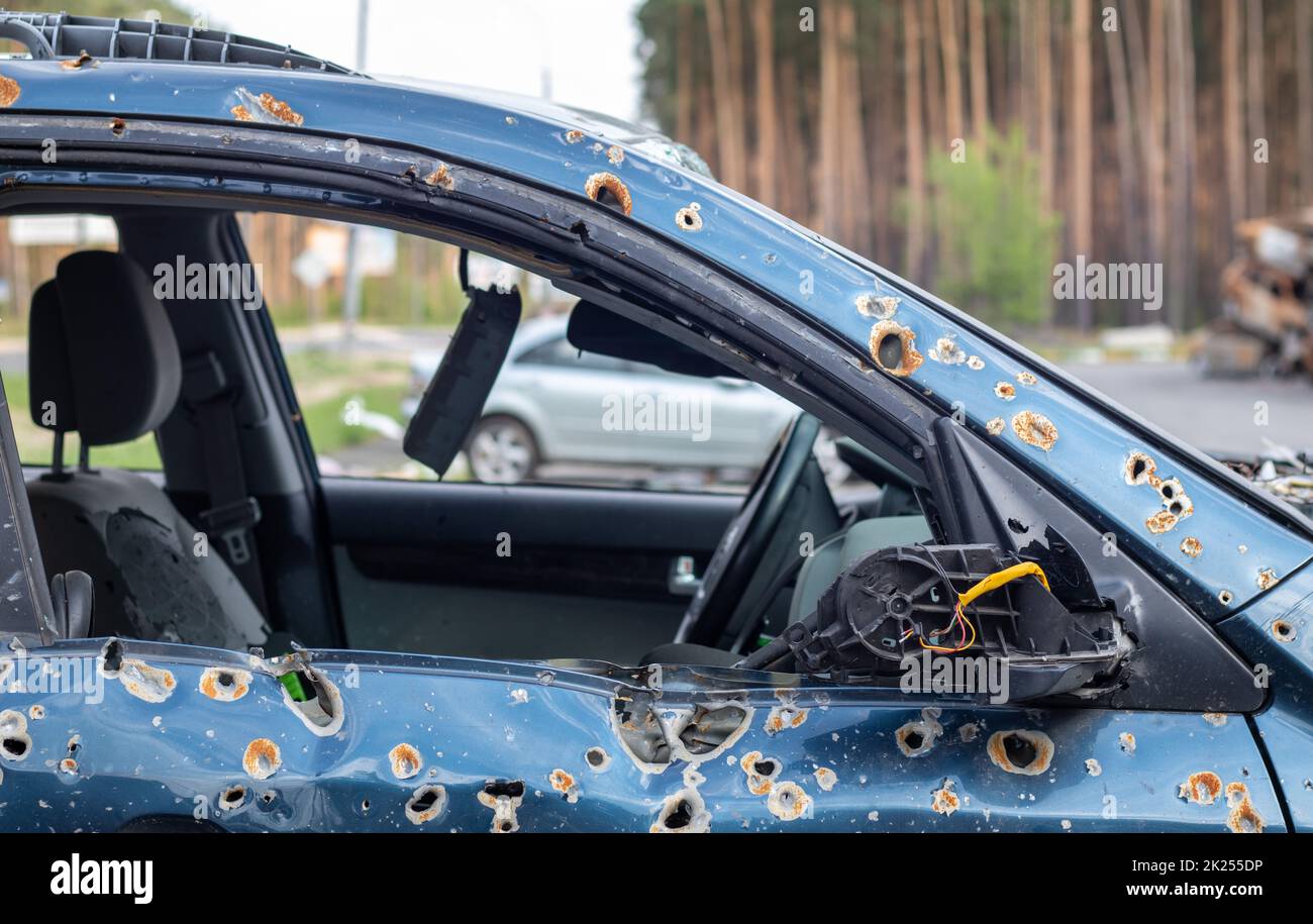 Car riddled with bullets. War of Russia against Ukraine. A car of ...