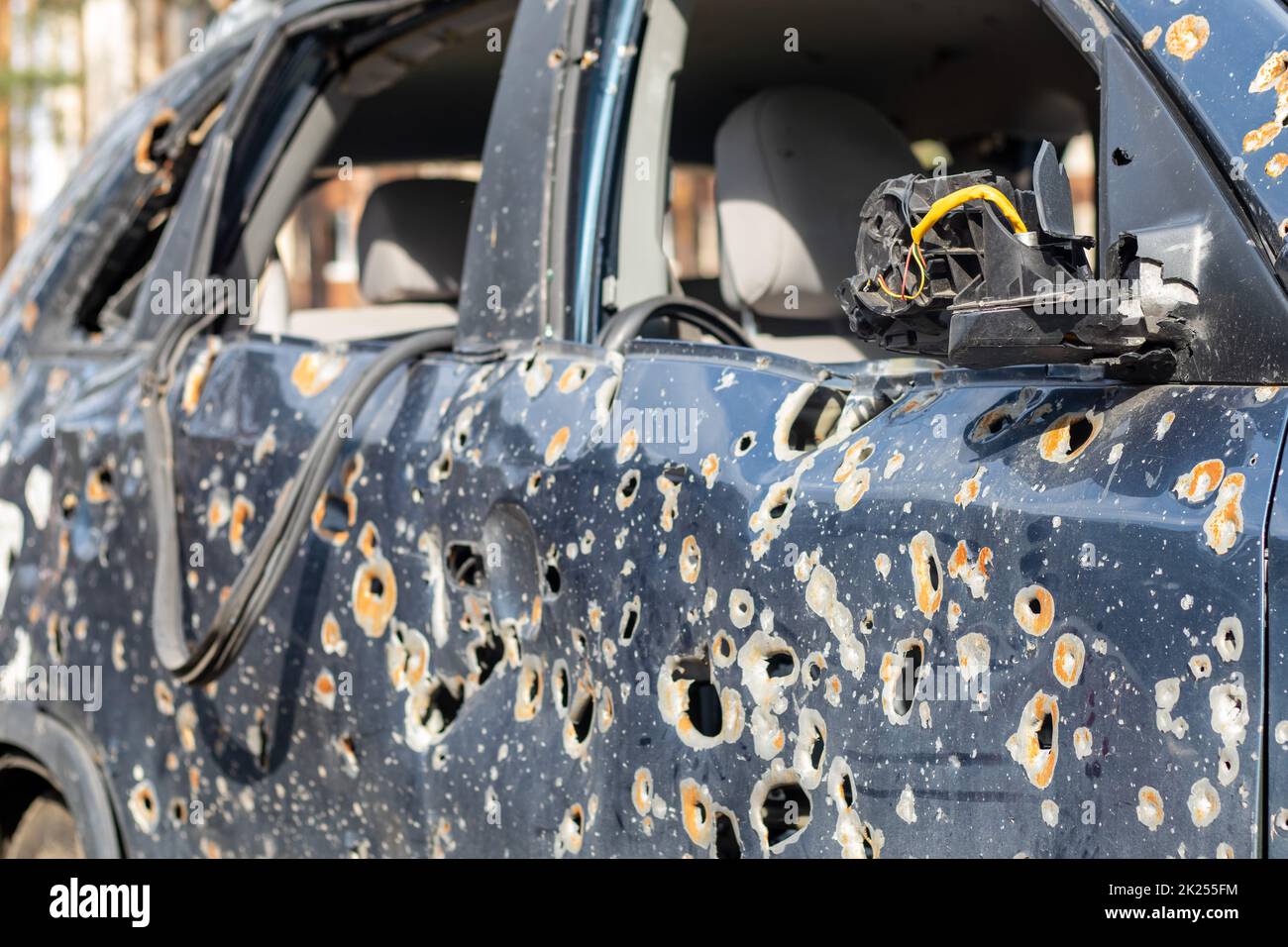 Car riddled with bullets. War of Russia against Ukraine. A car of ...