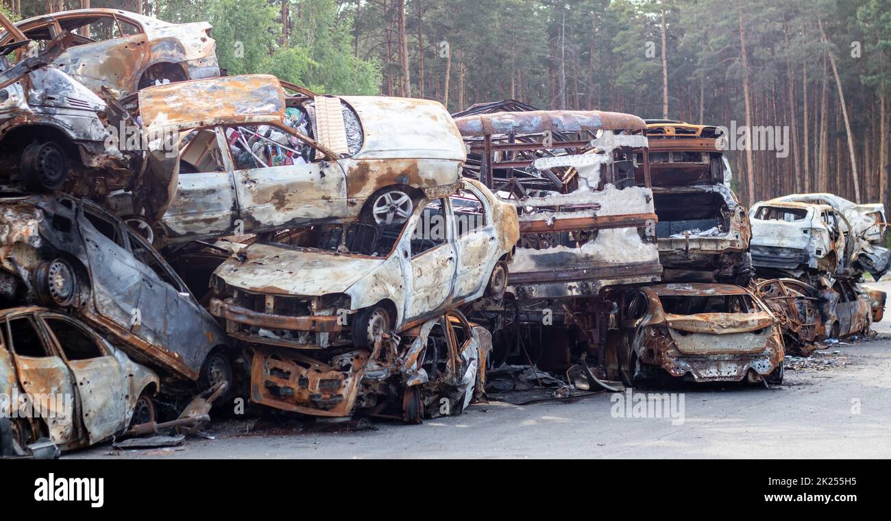 Rusty burnt cars destroyed by rocket explosions. War in Ukraine ...