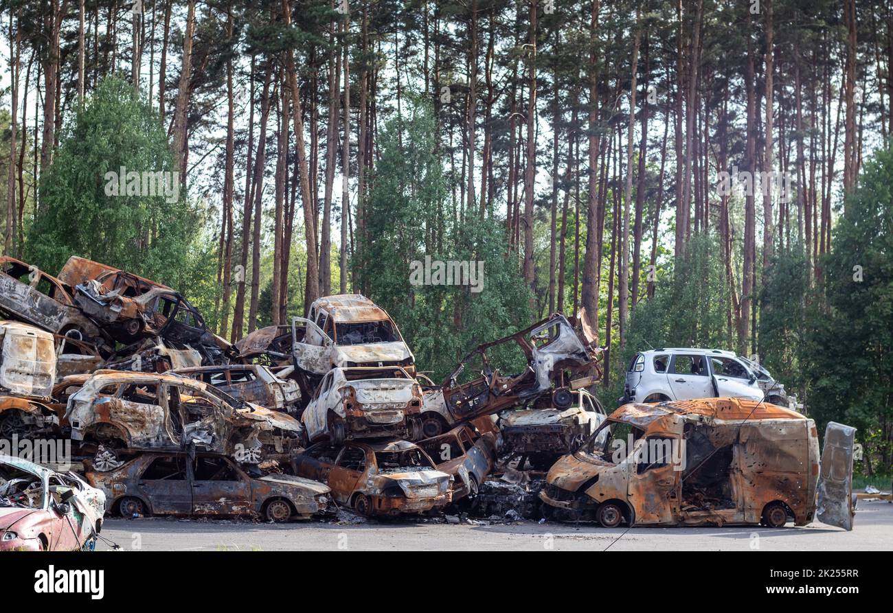 Rusty burnt cars destroyed by rocket explosions. War in Ukraine ...