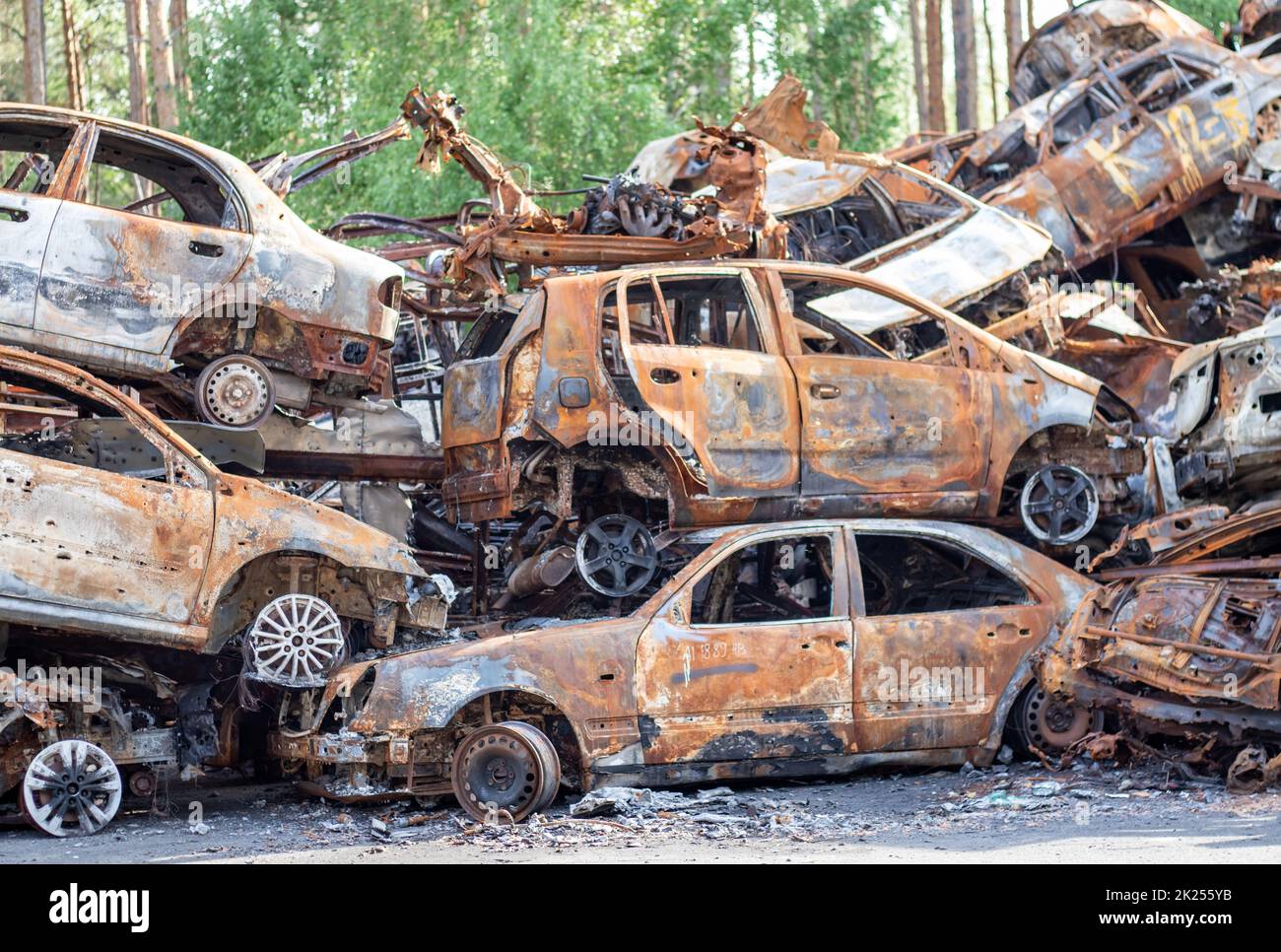 Rusty burnt cars destroyed by rocket explosions. War in Ukraine ...