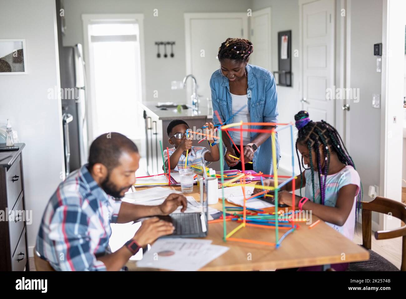 African american daughter doing homework table hi-res stock photography ...