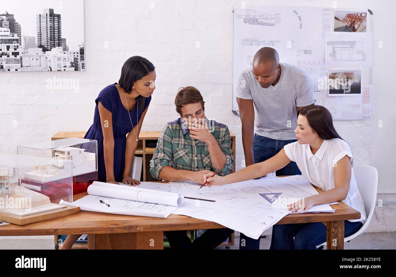 Coming together as a team. a young team of architects working together ...